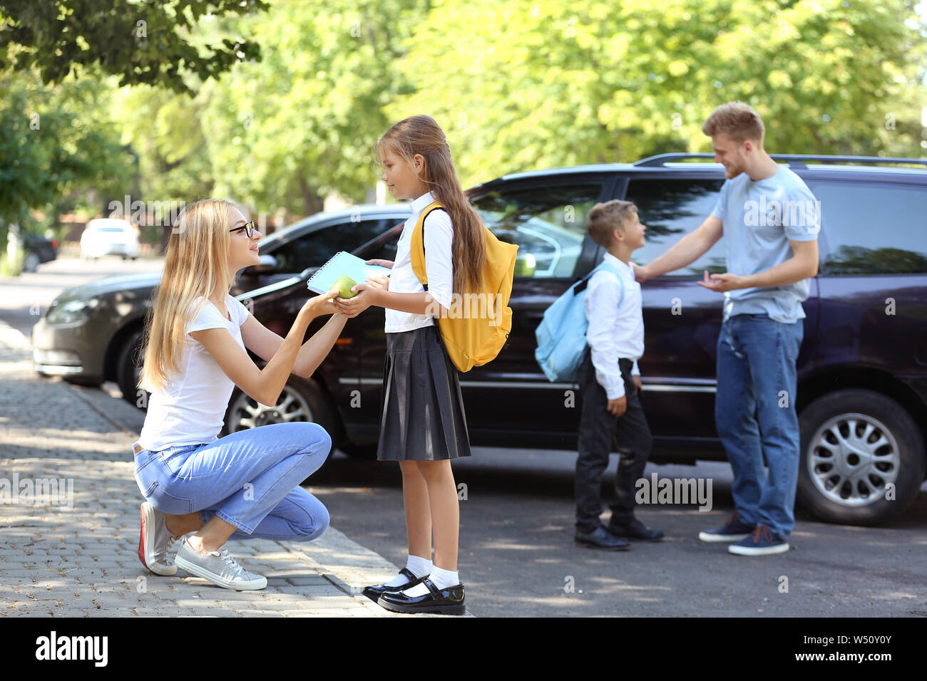 Parents saying goodbye to their children near school Stock Photo - Alamy