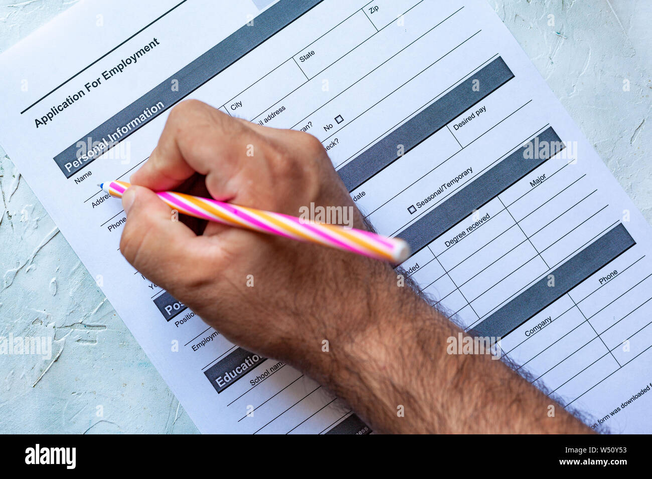 Hand filling Standard Application for Employment. HR, Hiring, Applicant ...