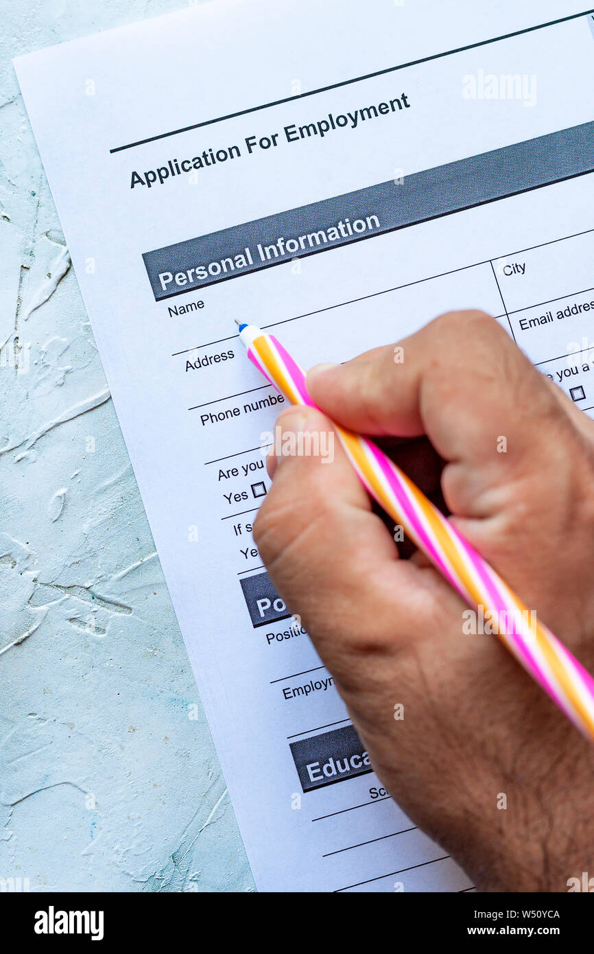 Hand filling Standard Application for Employment. HR, Hiring, Applicant ...