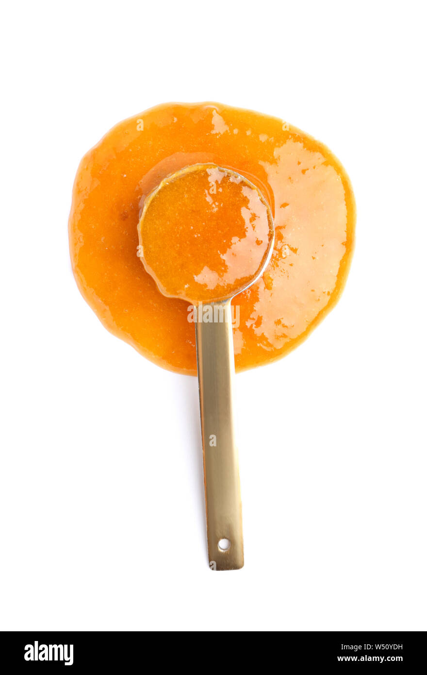 Scoop with tasty apricot jam on white background Stock Photo - Alamy