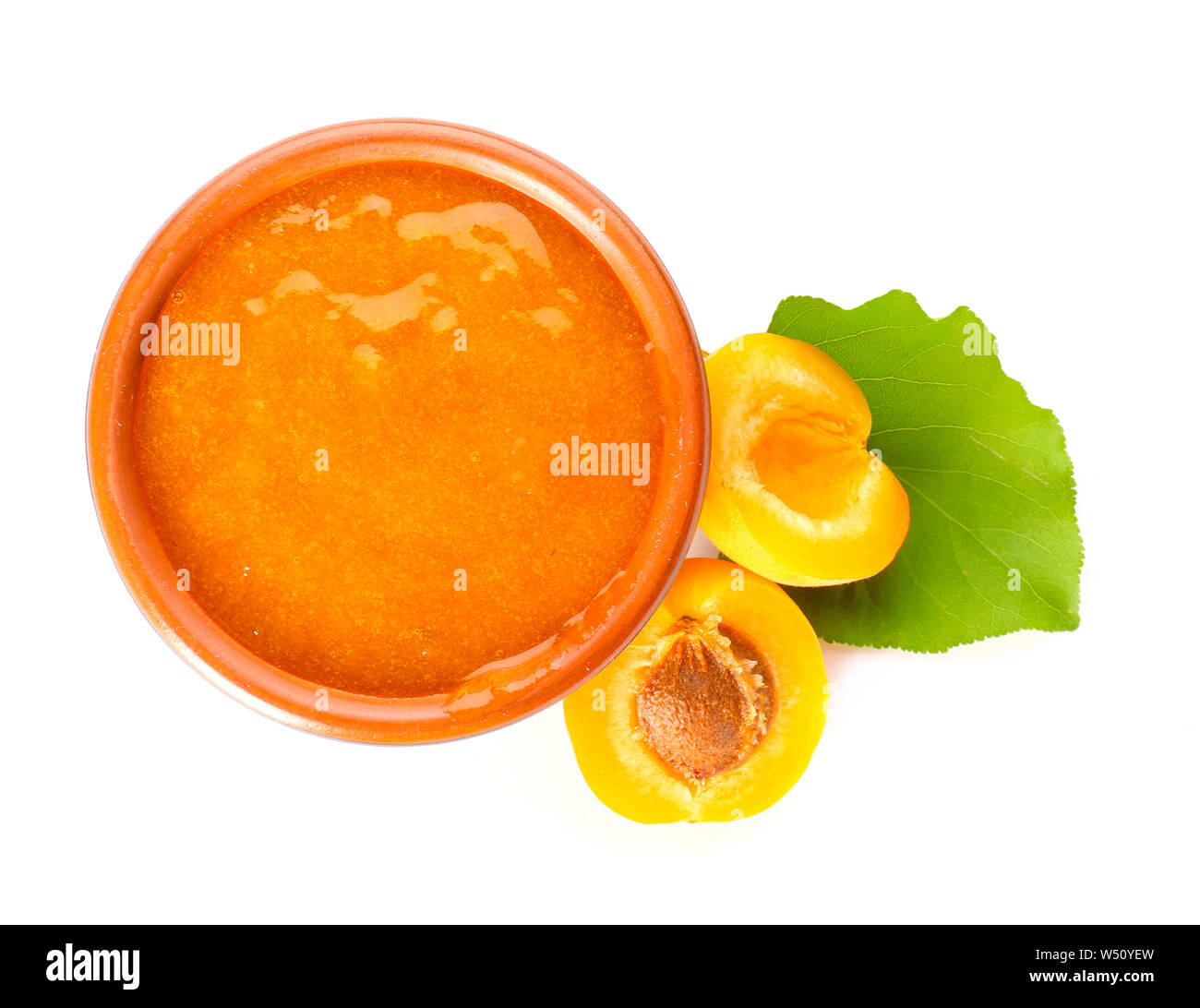 Bowl with tasty apricot jam on white background Stock Photo - Alamy