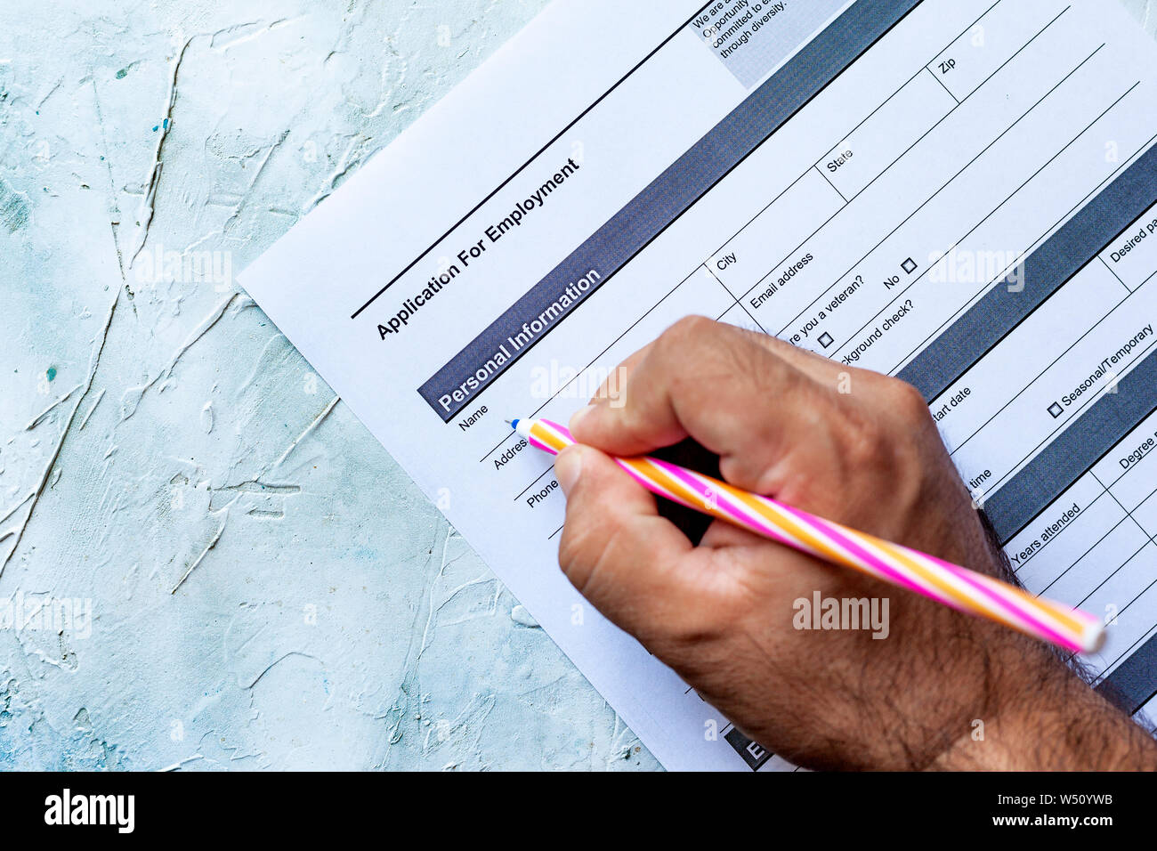 Hand filling Standard Application for Employment. HR, Hiring, Applicant ...