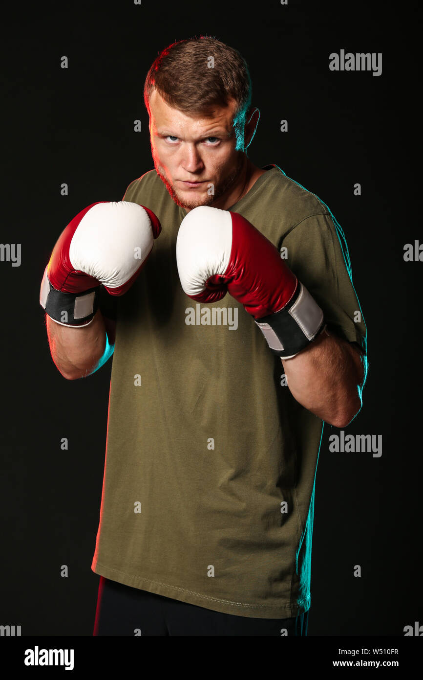 Strong male boxer on dark background Stock Photo - Alamy