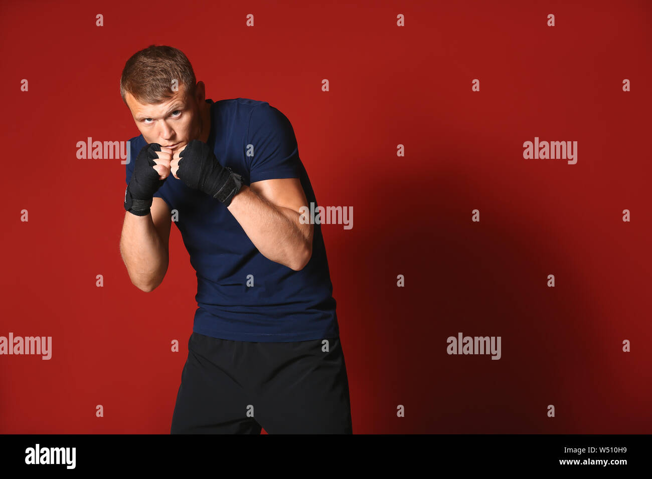 Strong male boxer on color background Stock Photo - Alamy