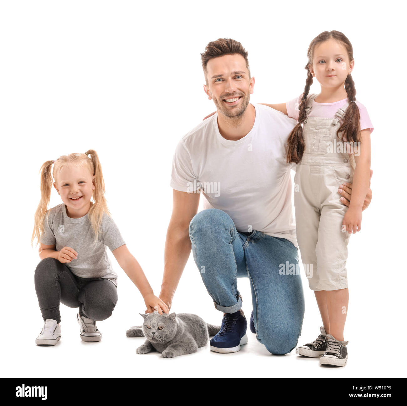 Happy father and daughters with cute cat on white background Stock ...