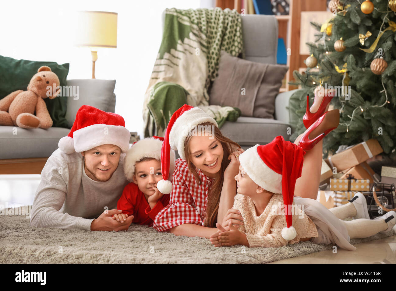Happy family at home on Christmas eve Stock Photo - Alamy