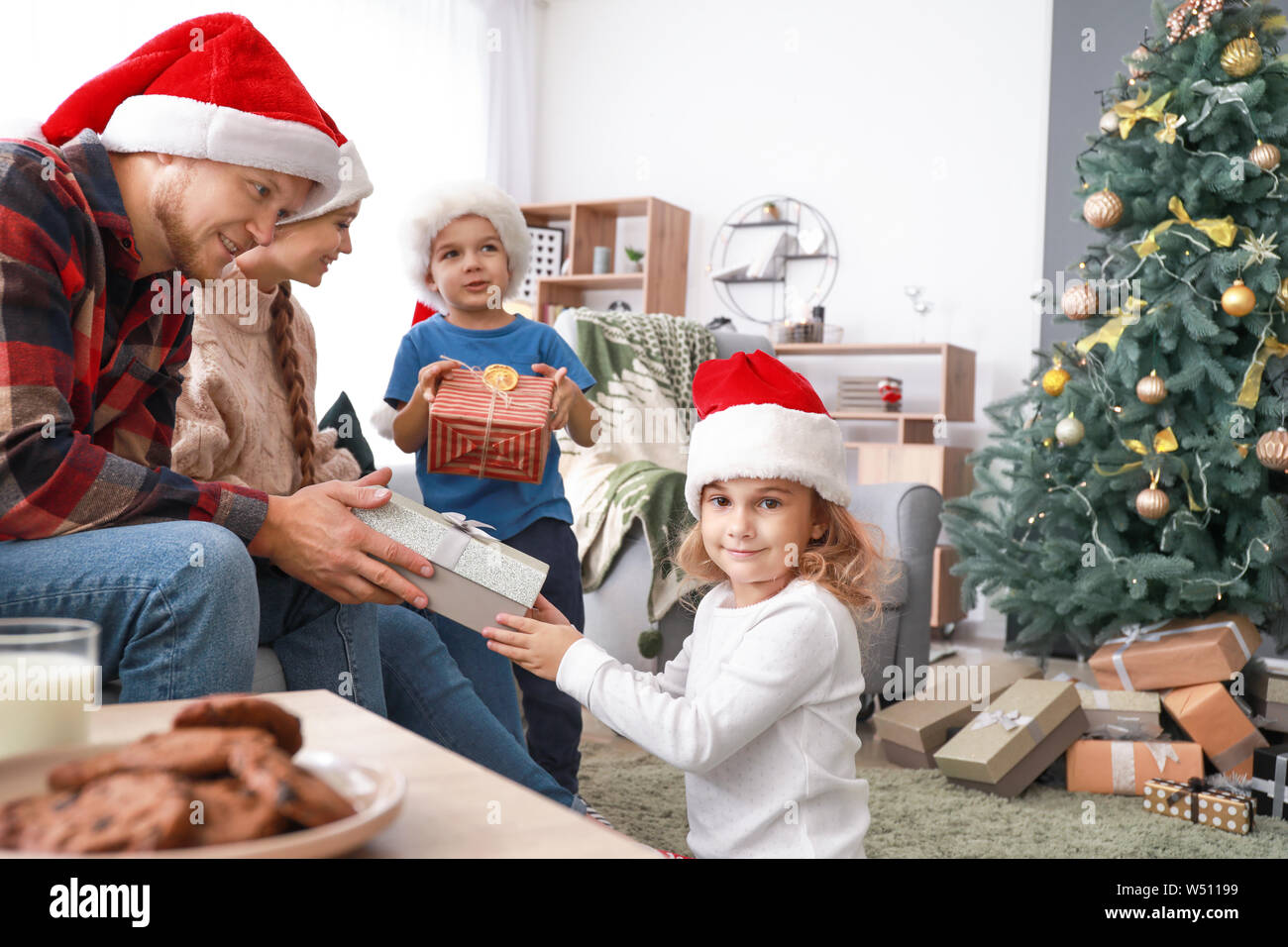 Children greeting their parents on Christmas eve Stock Photo - Alamy
