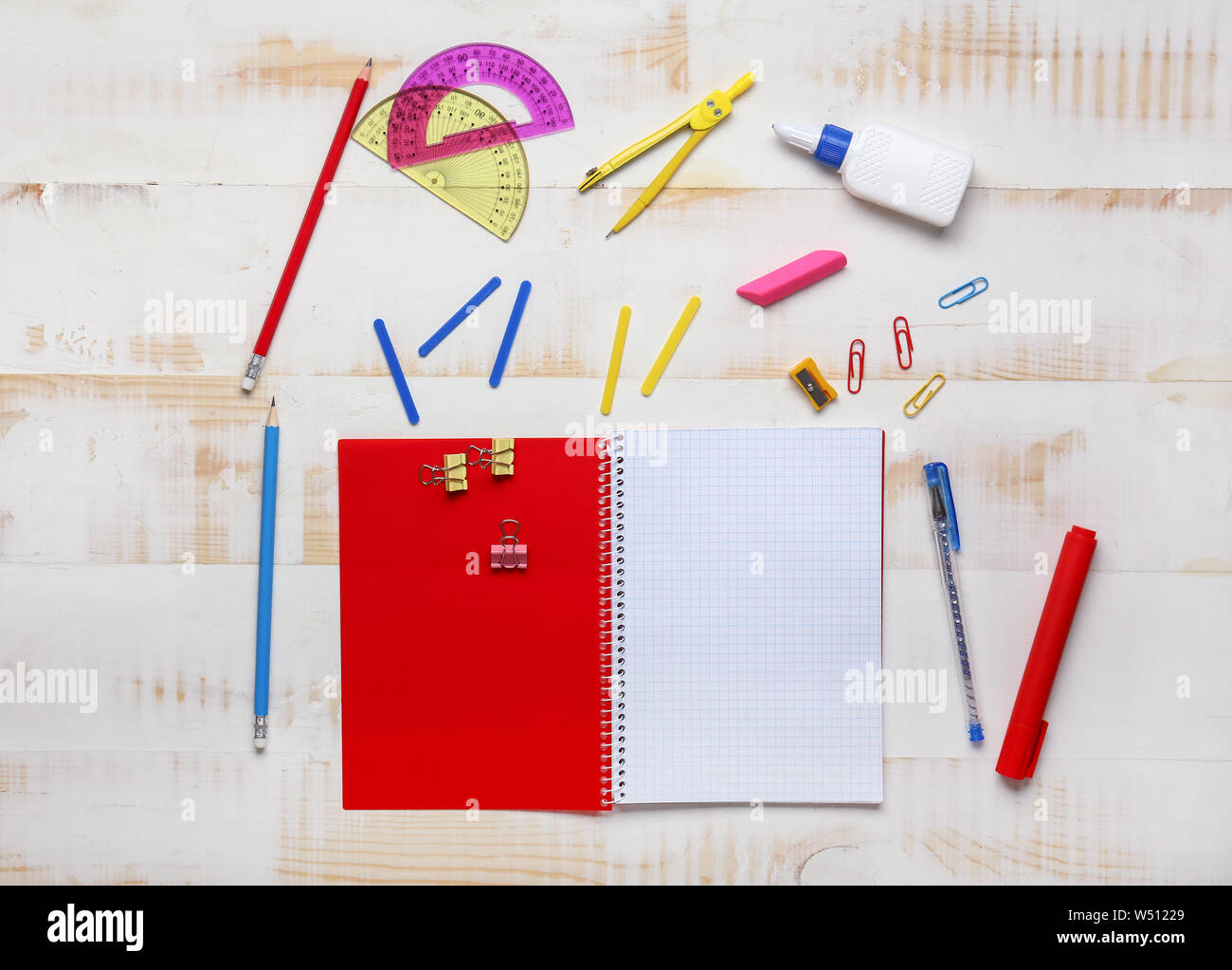 Set of school supplies on white wooden background Stock Photo - Alamy