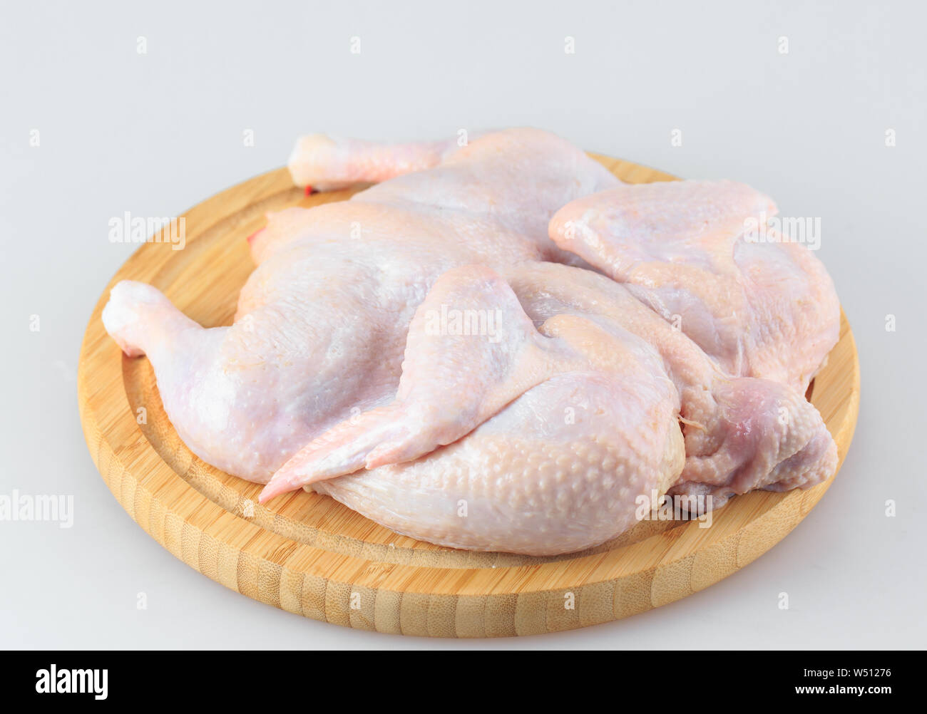 Raw chicken carcass on the cutting board isolated on white background ...
