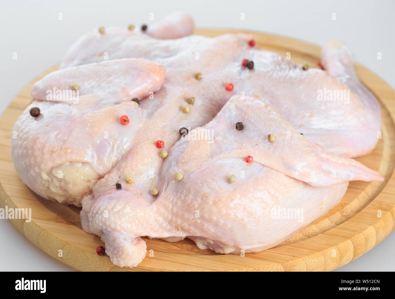 Raw chicken carcass on the cutting board isolated on white background ...