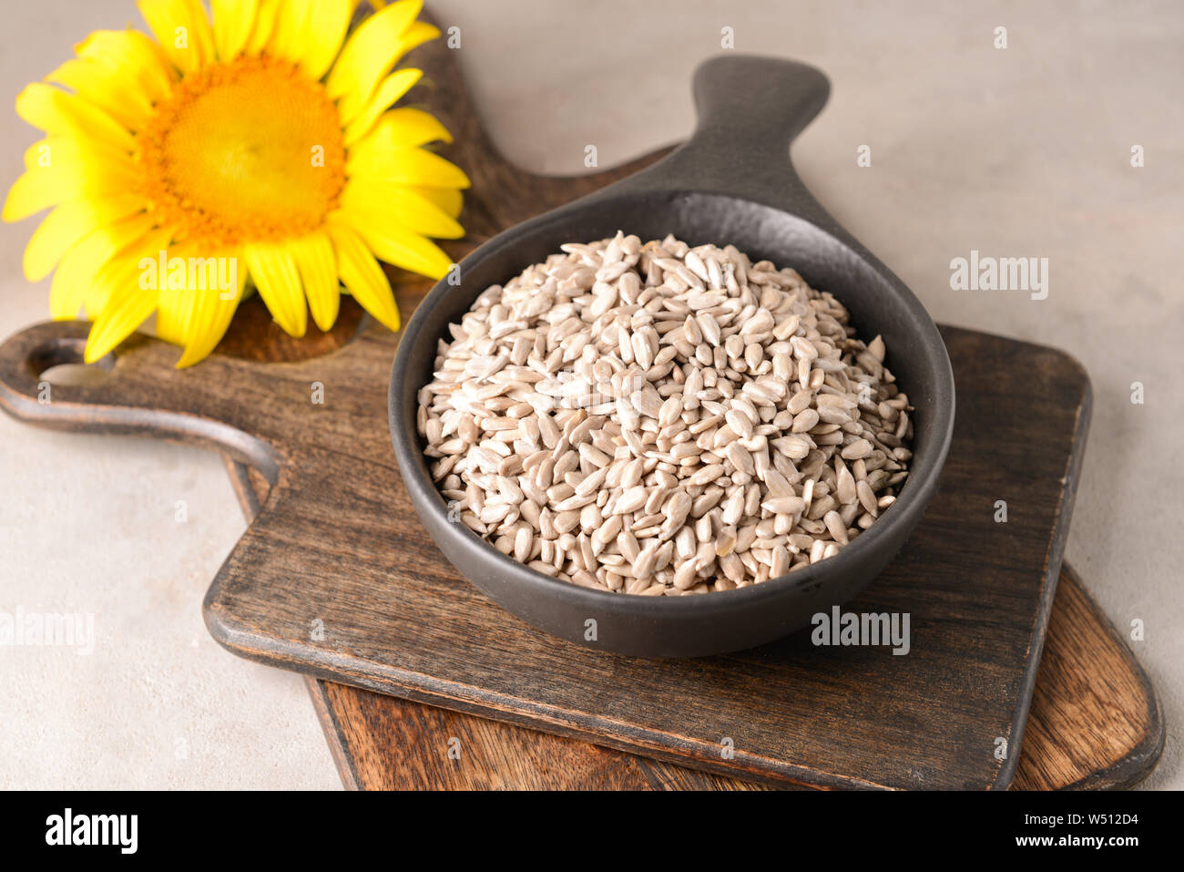 Pan with sunflower seeds on table Stock Photo - Alamy