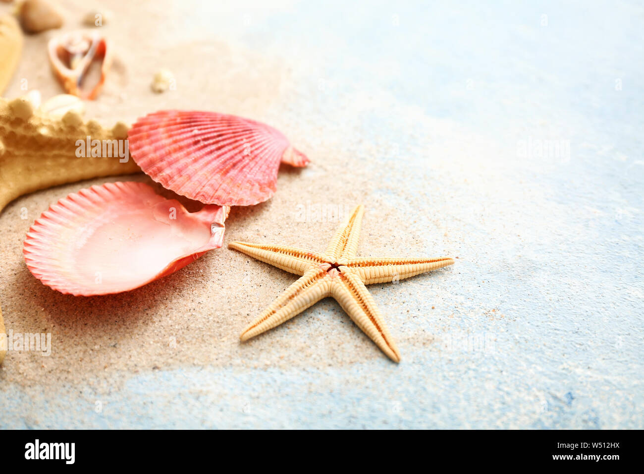 Beautiful sea shells, starfish and sand on color background Stock Photo ...