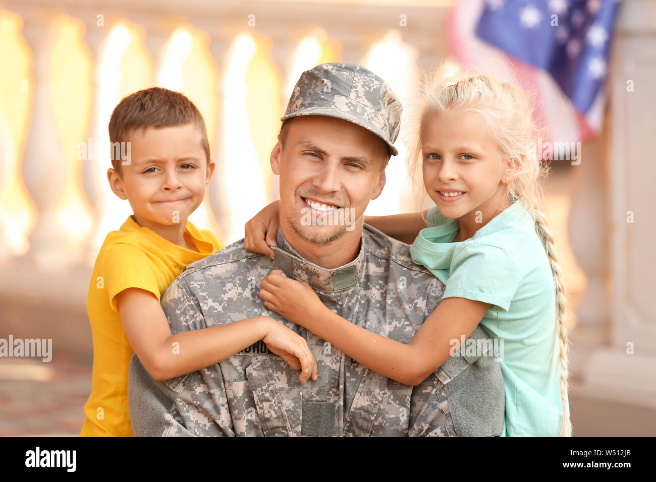 Happy military man with his children outdoors Stock Photo - Alamy