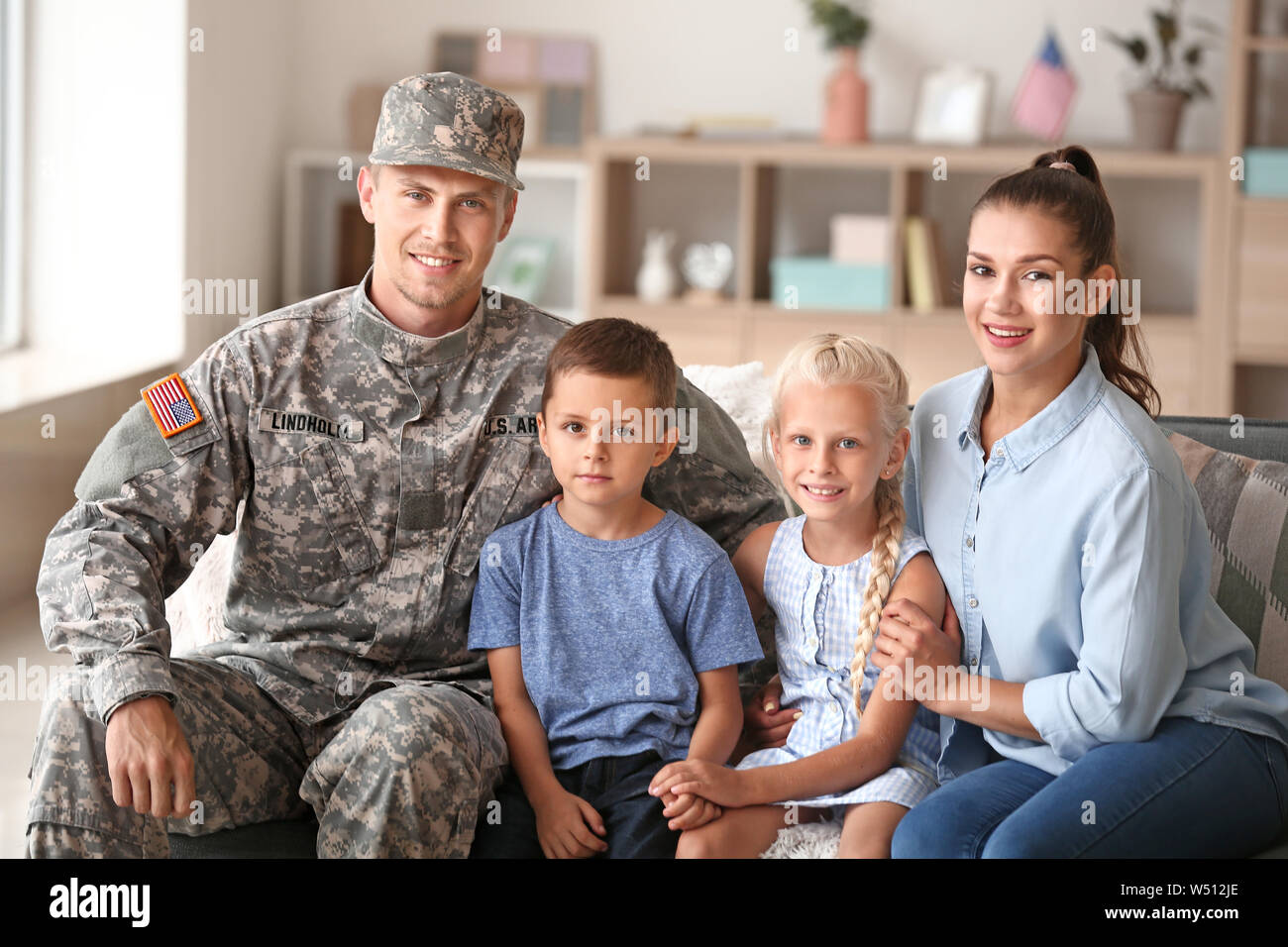 Happy military man with his family at home Stock Photo - Alamy