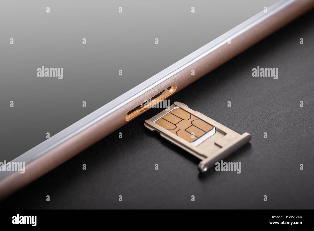 mobile phone and sim card on a black background Stock Photo - Alamy