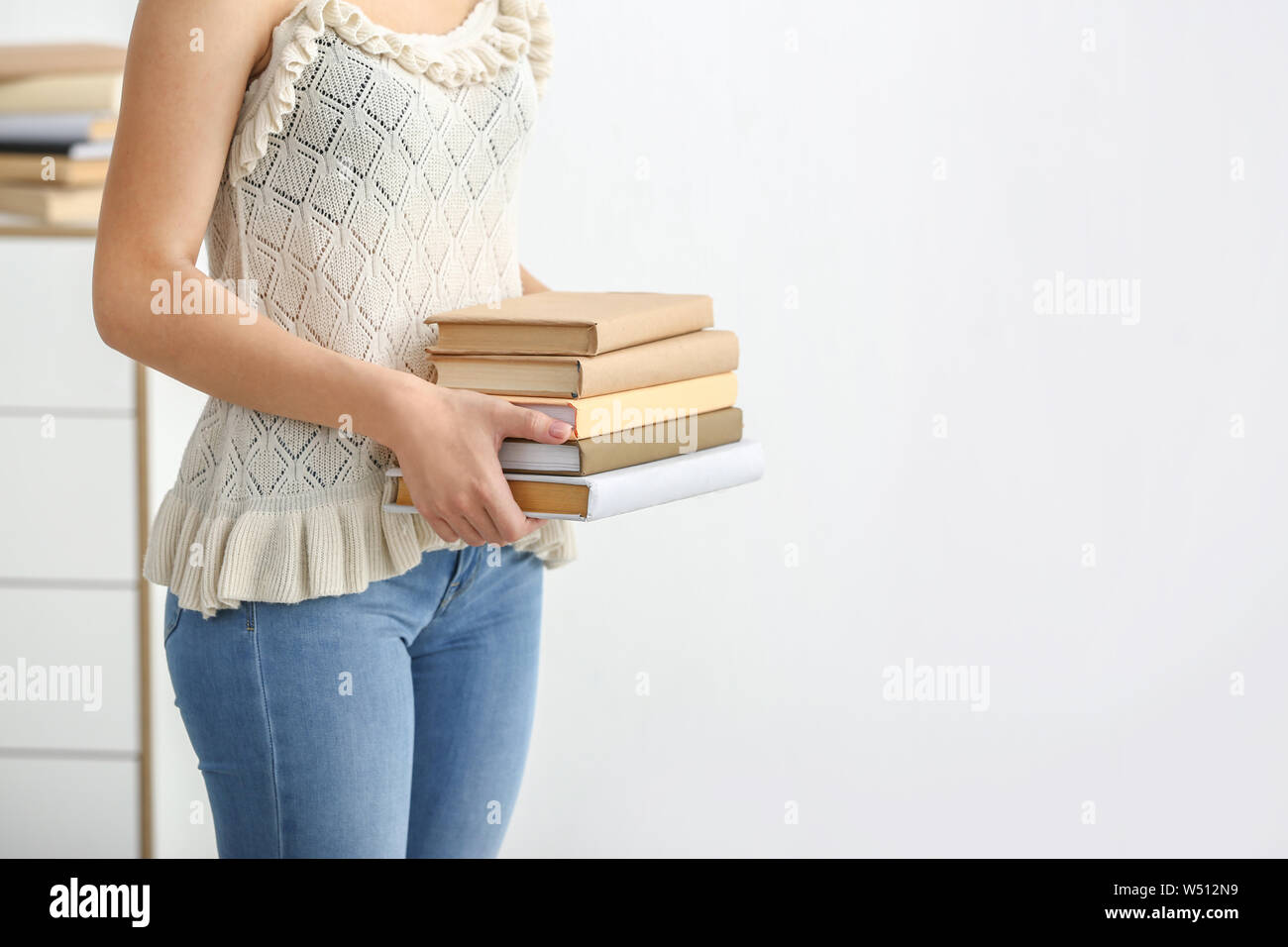 Woman with books on white background Stock Photo - Alamy