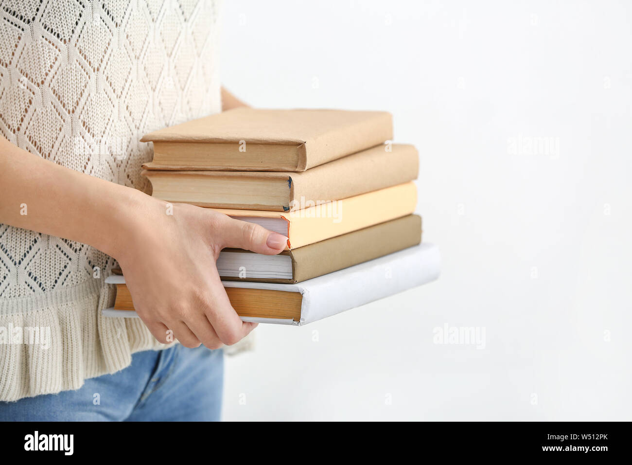 Woman with books on white background Stock Photo - Alamy