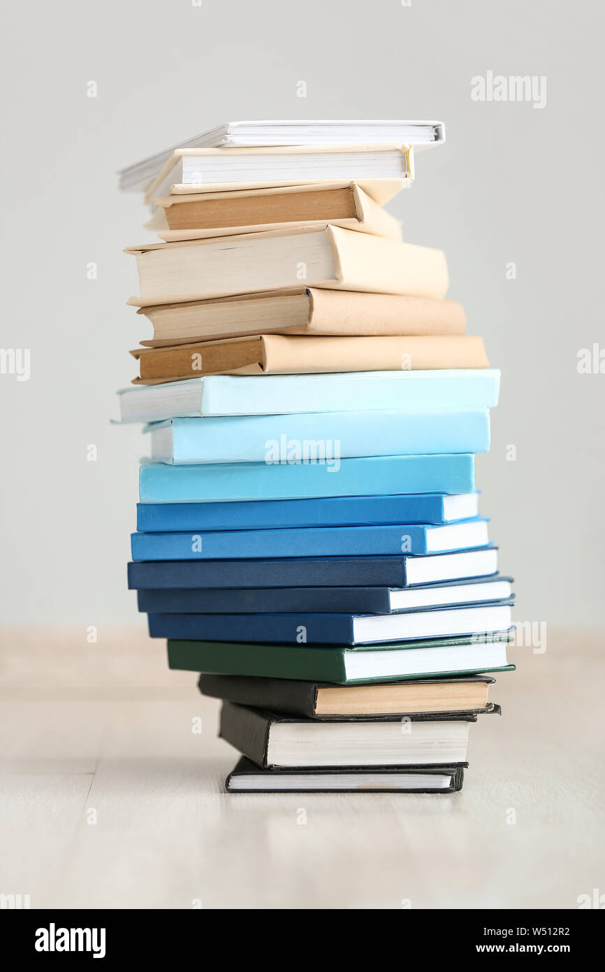 Stack of different books on light background Stock Photo - Alamy
