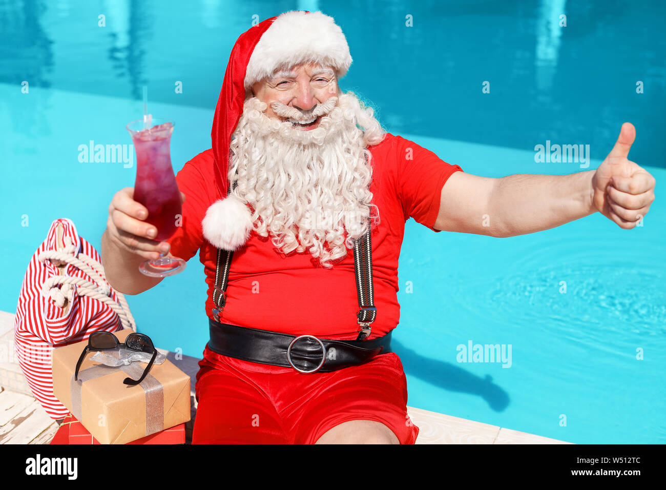 Santa Claus with cocktail near swimming pool at resort Stock Photo - Alamy