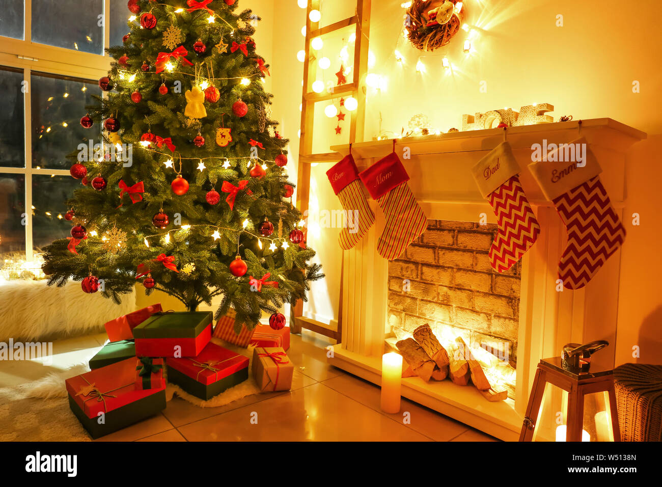 Beautifully decorated Christmas tree with gift boxes in room Stock ...
