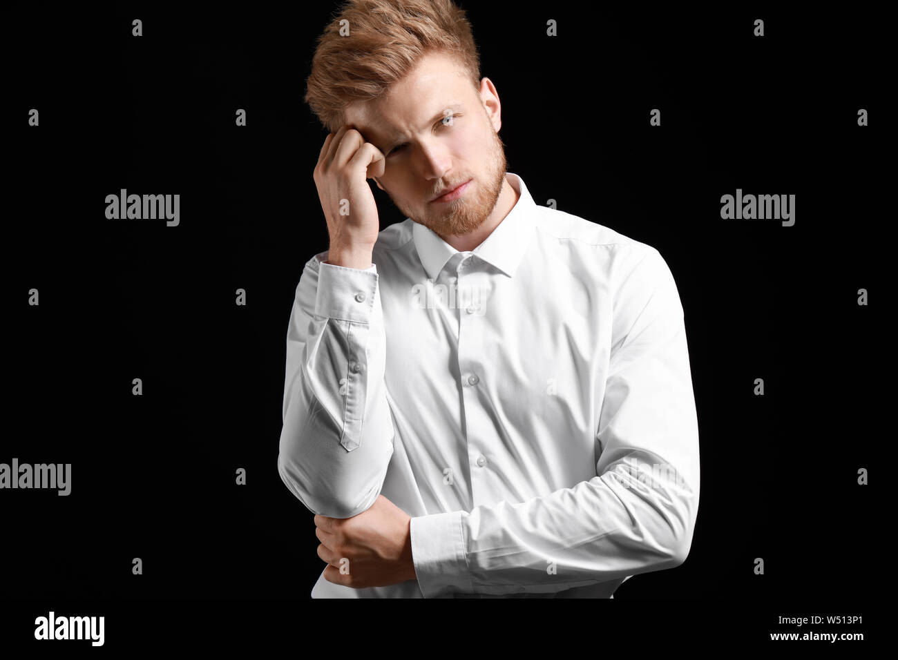 Stressed young man on dark background Stock Photo - Alamy