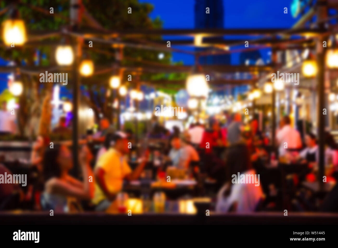 blurred image Lots of people enjoy at the bar pub fun of night festival ...