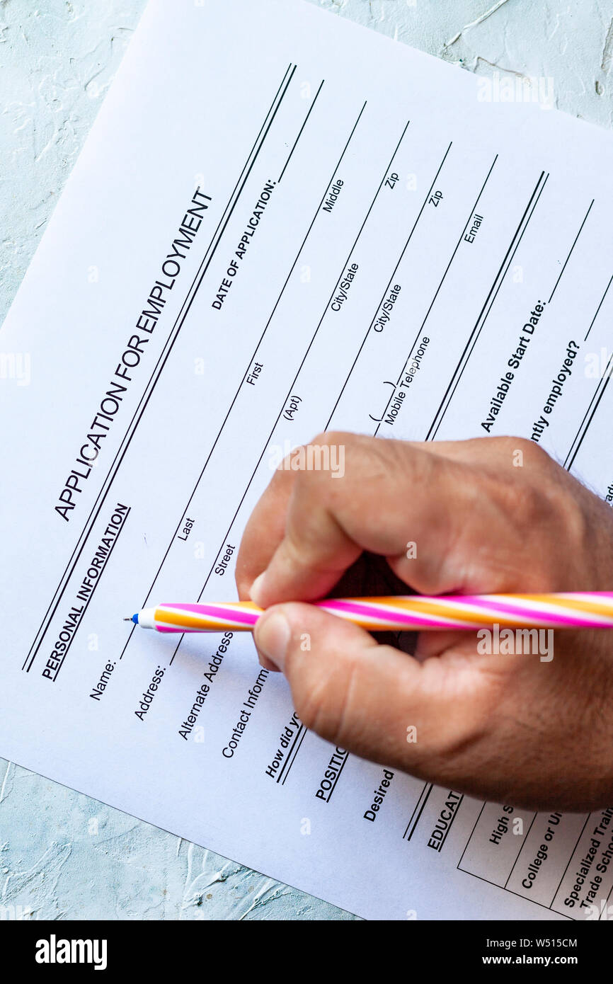Hand filling Standard Application for Employment. HR, Hiring, Applicant ...