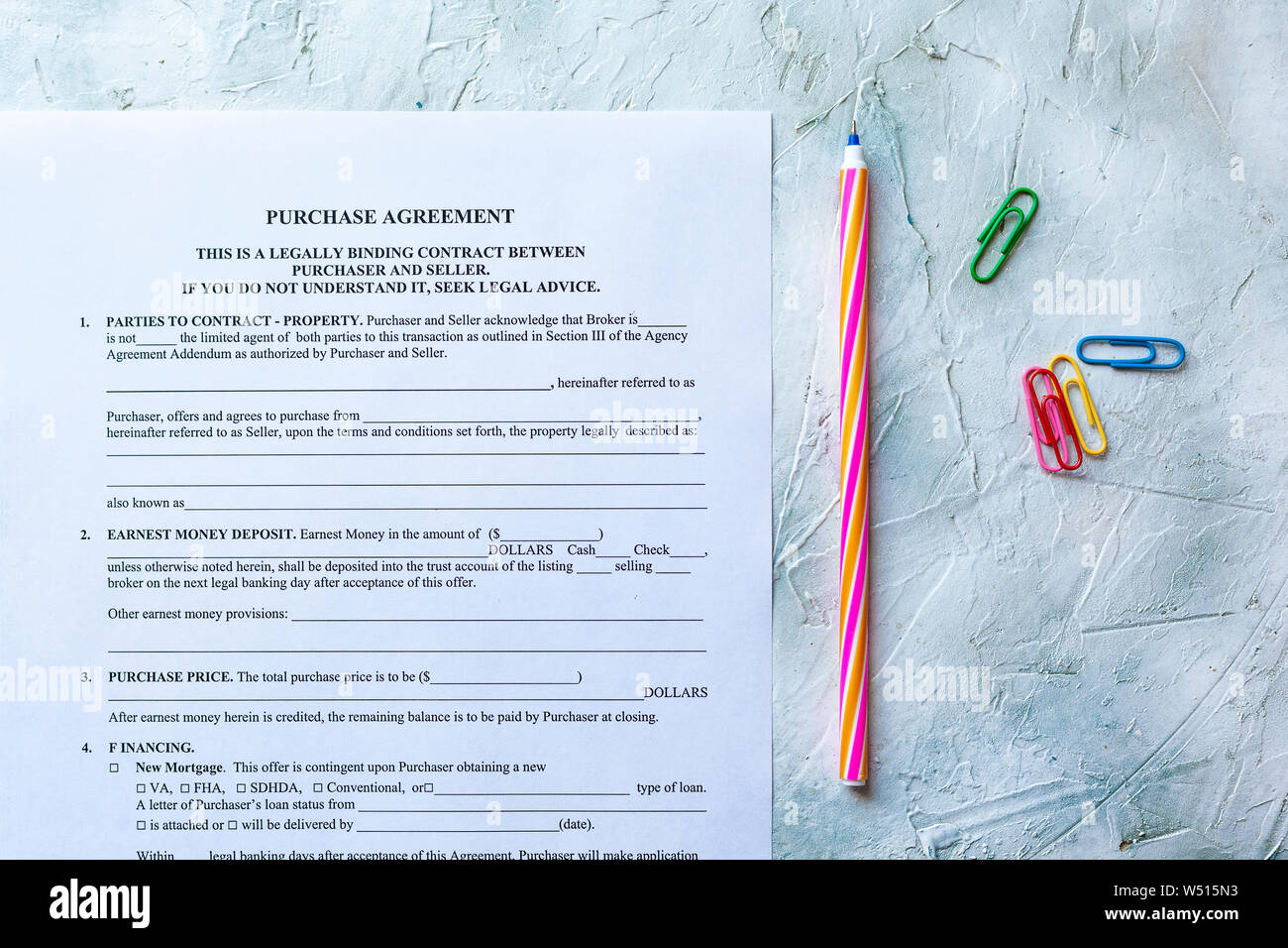 Filling blank Purchase agreement form. View from above Stock Photo - Alamy
