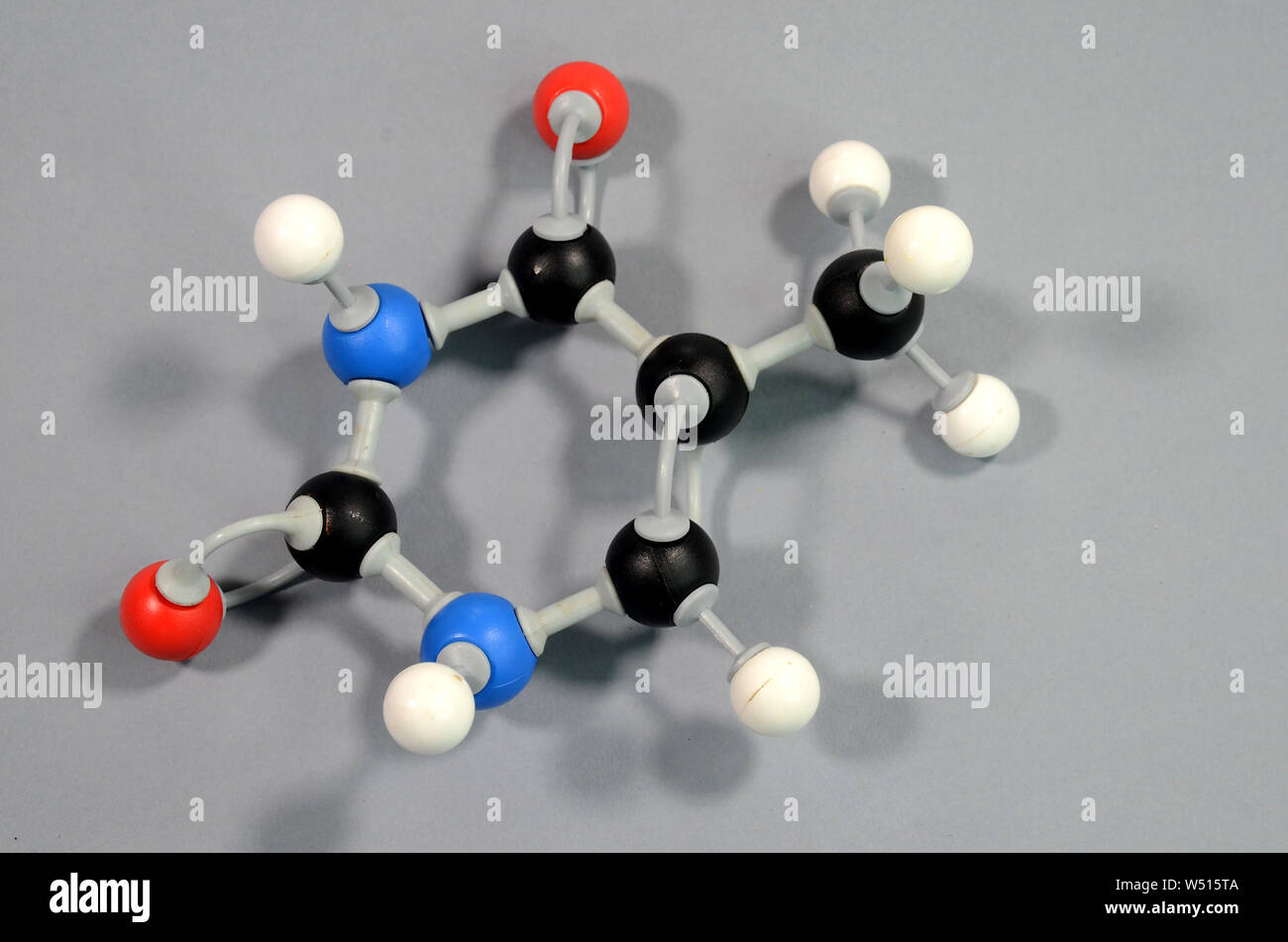Molecule model of the DNA element Thymine. Black is Carbon, Red is ...
