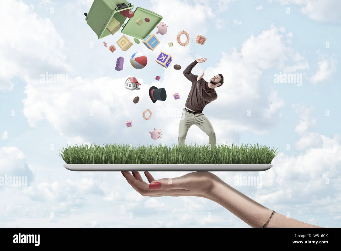 Female hand holding a grass model with a man in casual clothes ...