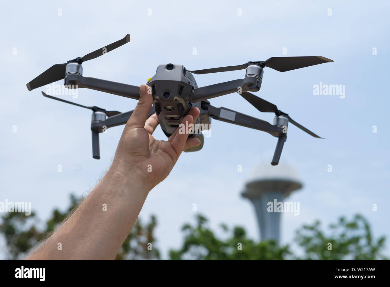 Female hand launches drone for flight, with which you can take photos ...