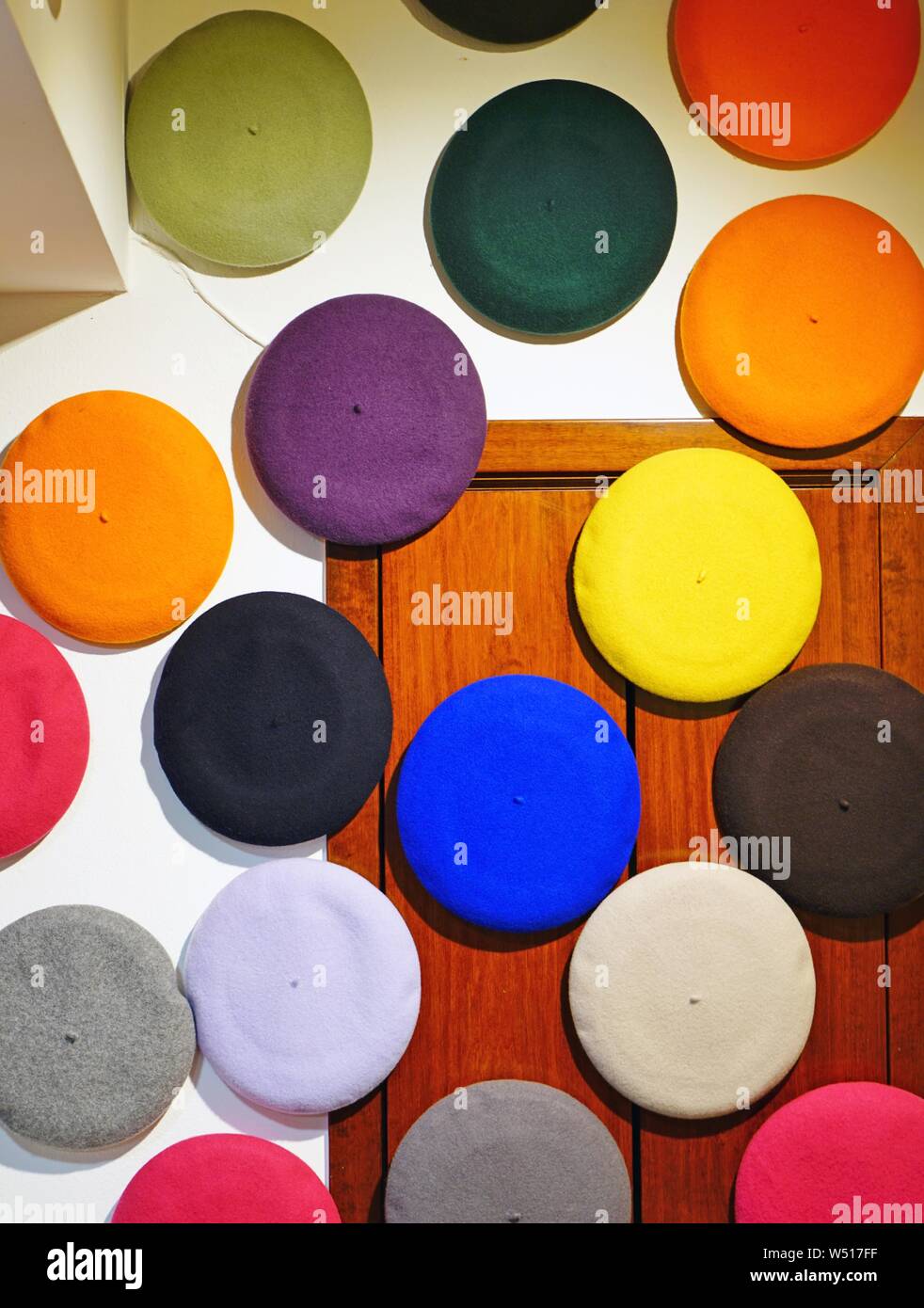 Colorful beret hats on display on a store wall Stock Photo - Alamy