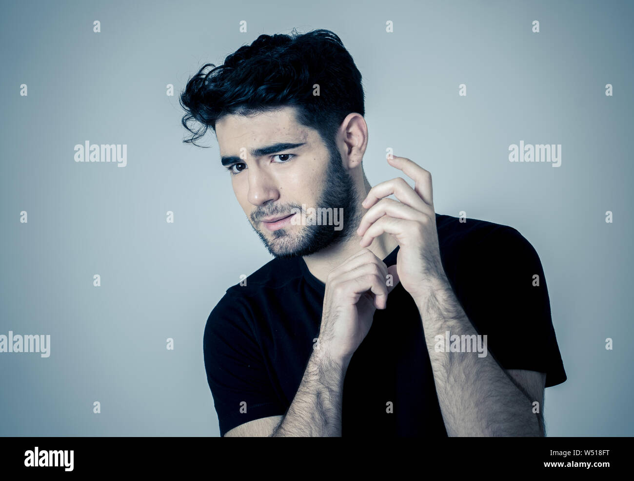 Young man feeling scared and shocked making fear anxiety gestures ...