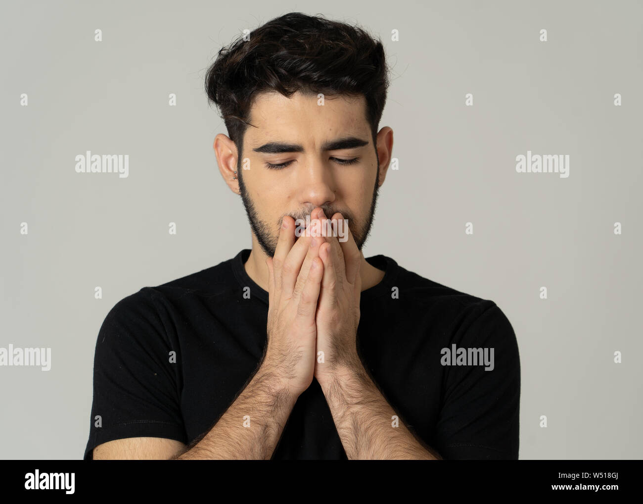 Young sad man suffering from depression looking serious and concerned ...