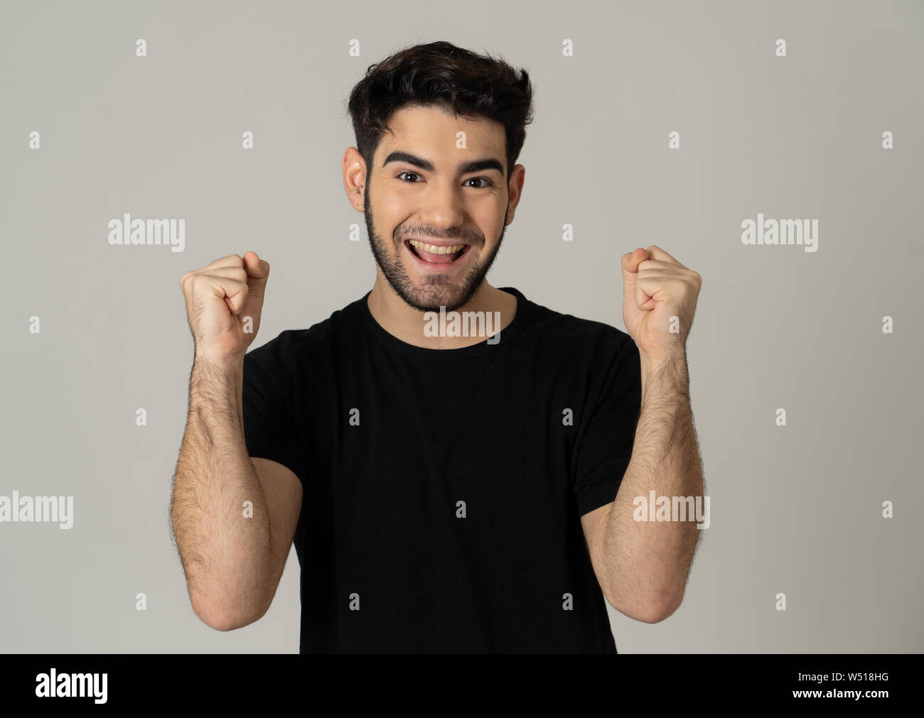 Portrait of young man celebrating achieving his goal, wining the ...