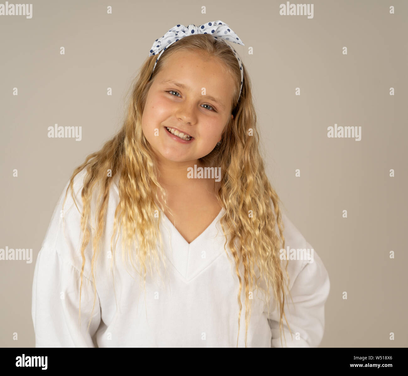 Cute charming happy excited and cheerful young kid modeling and posing ...