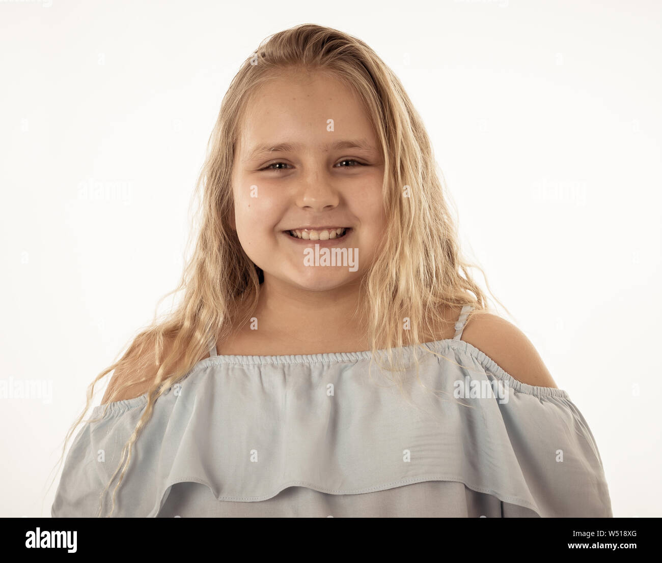 Close up portrait. Cute happy, confident, successful, proud little girl smiling at the camera ...