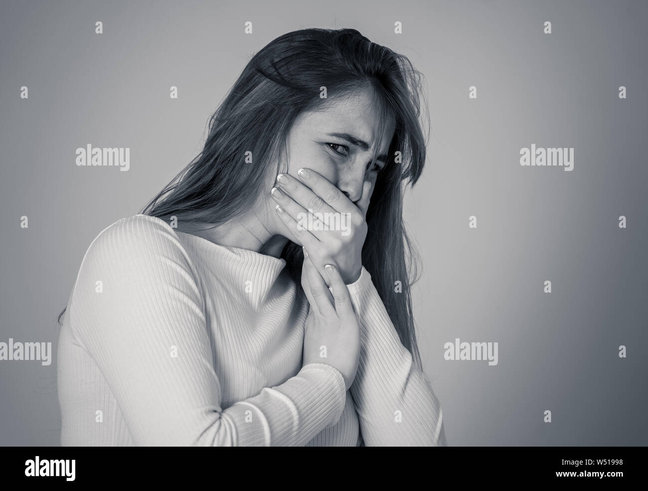 Close up portrait of young teen woman feeling afraid and shocked hiding ...