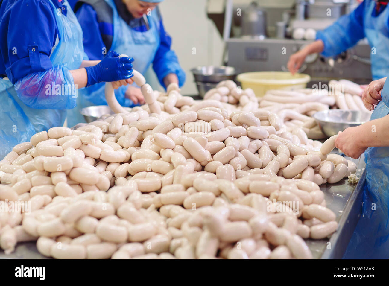 Butchers processing sausages at a meat factory Stock Photo - Alamy