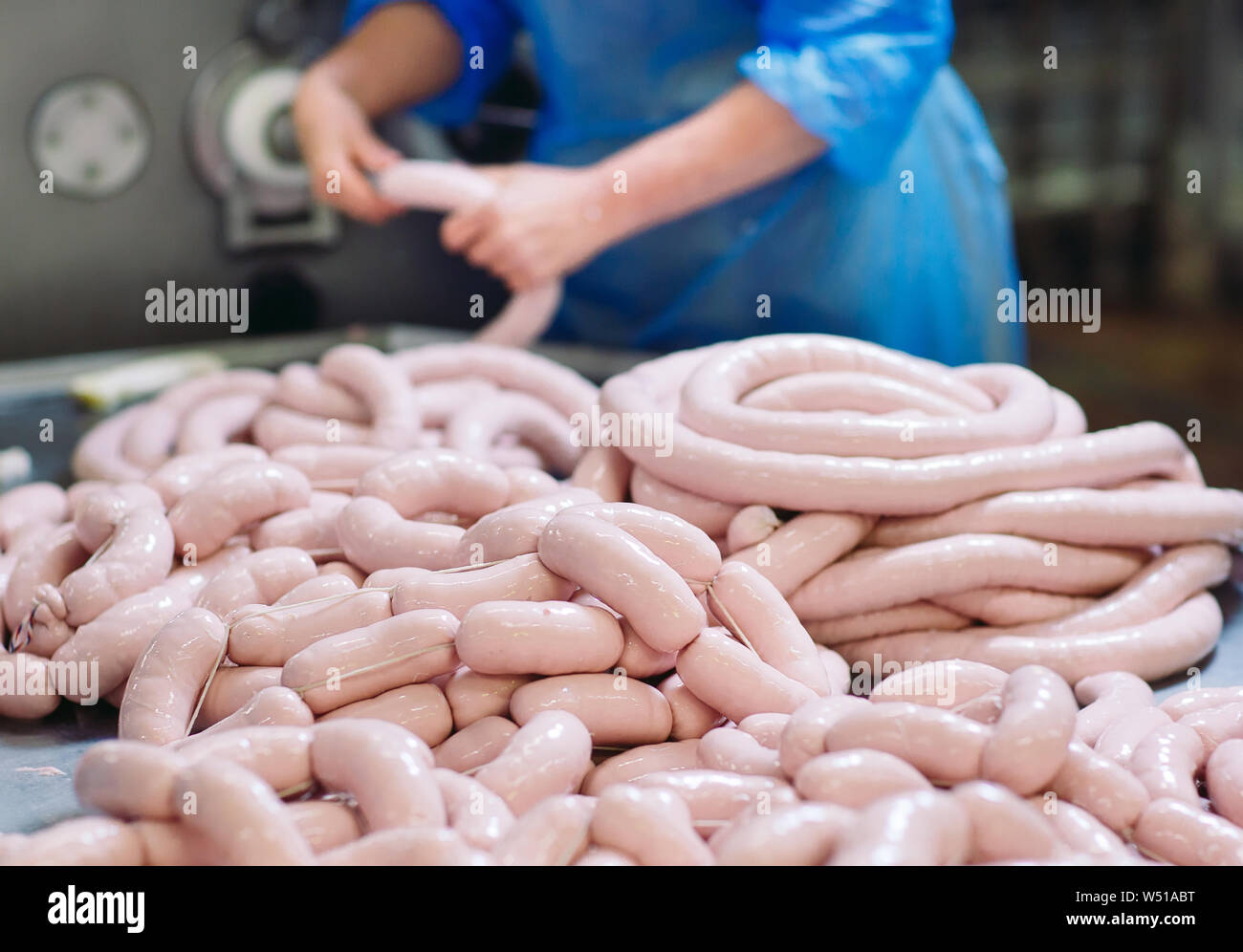 Butchers processing sausages at a meat factory Stock Photo - Alamy