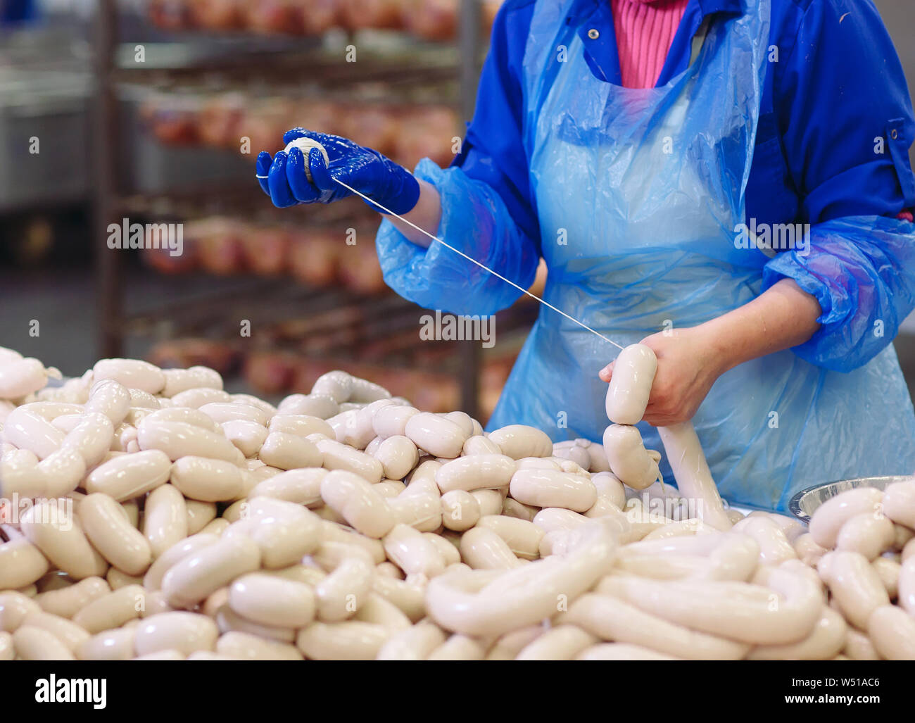 Butchers processing sausages at a meat factory Stock Photo - Alamy