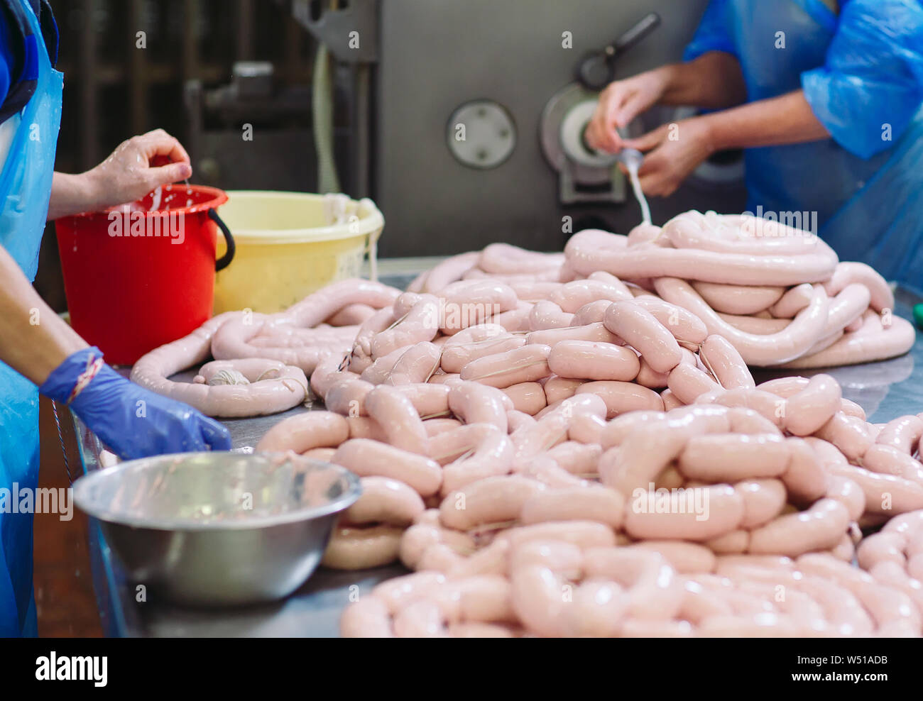 Butchers processing sausages at a meat factory Stock Photo - Alamy