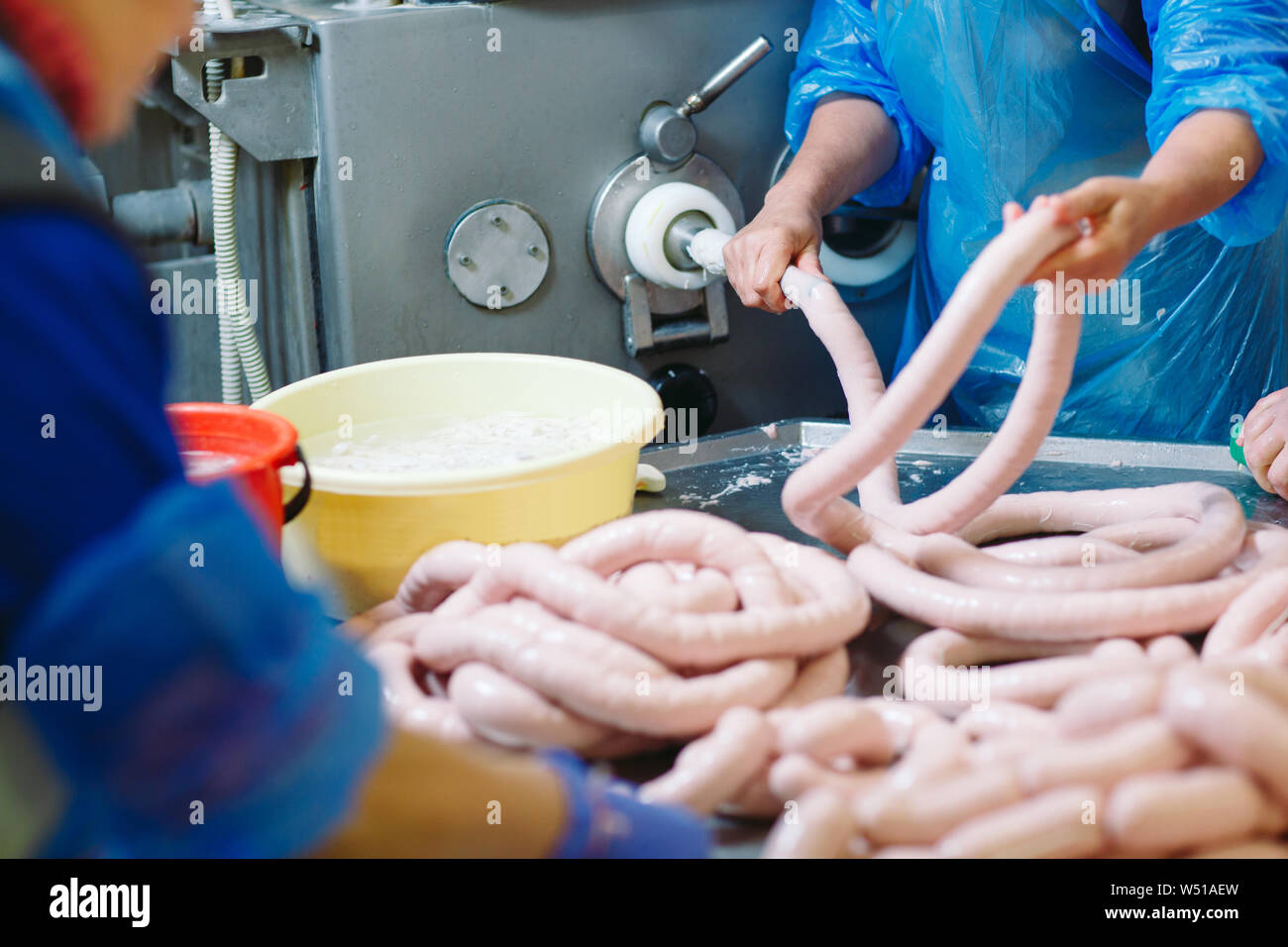 Butchers processing sausages at a meat factory Stock Photo - Alamy