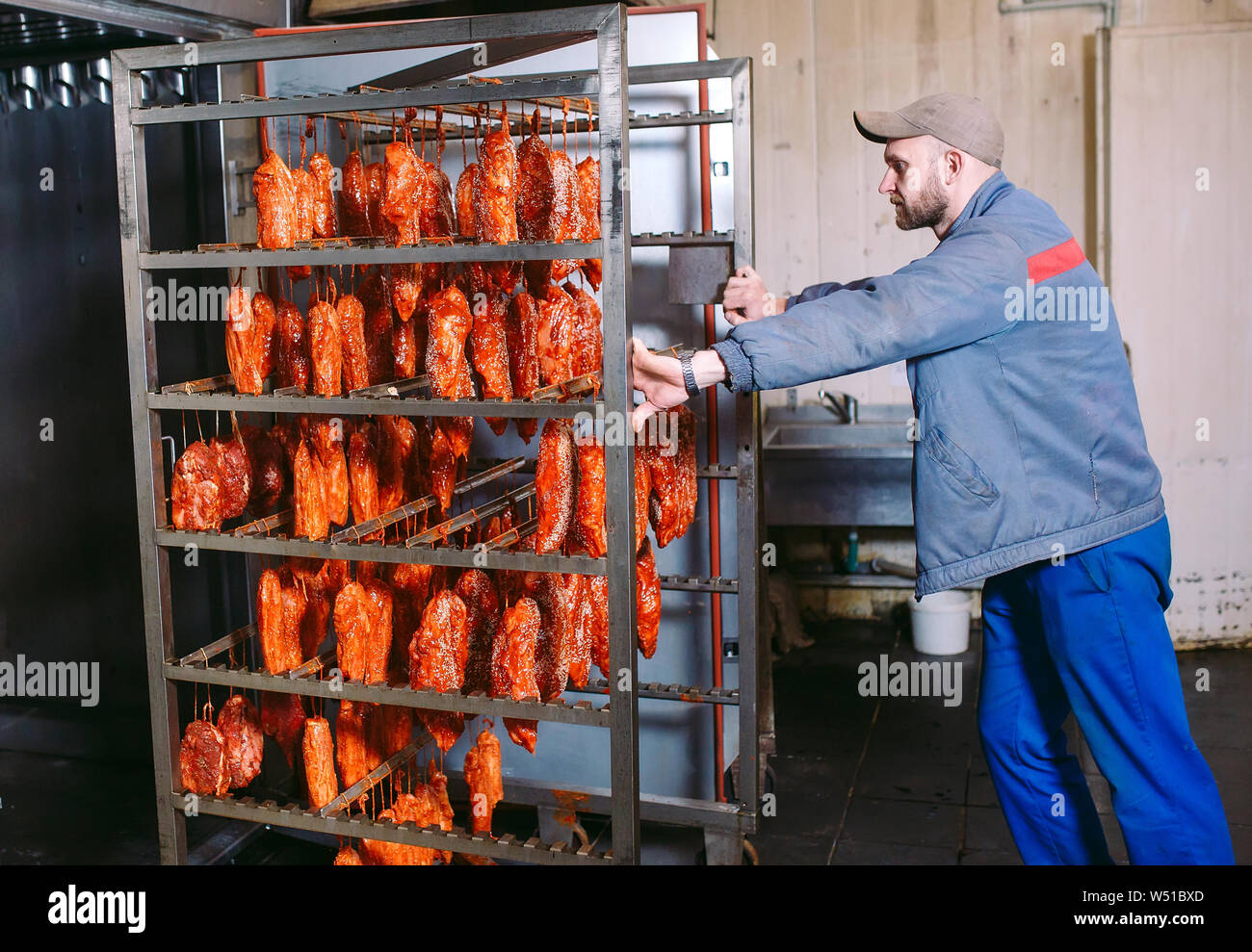 Smoked ham in the oven. Sausage production in the factory Stock Photo ...