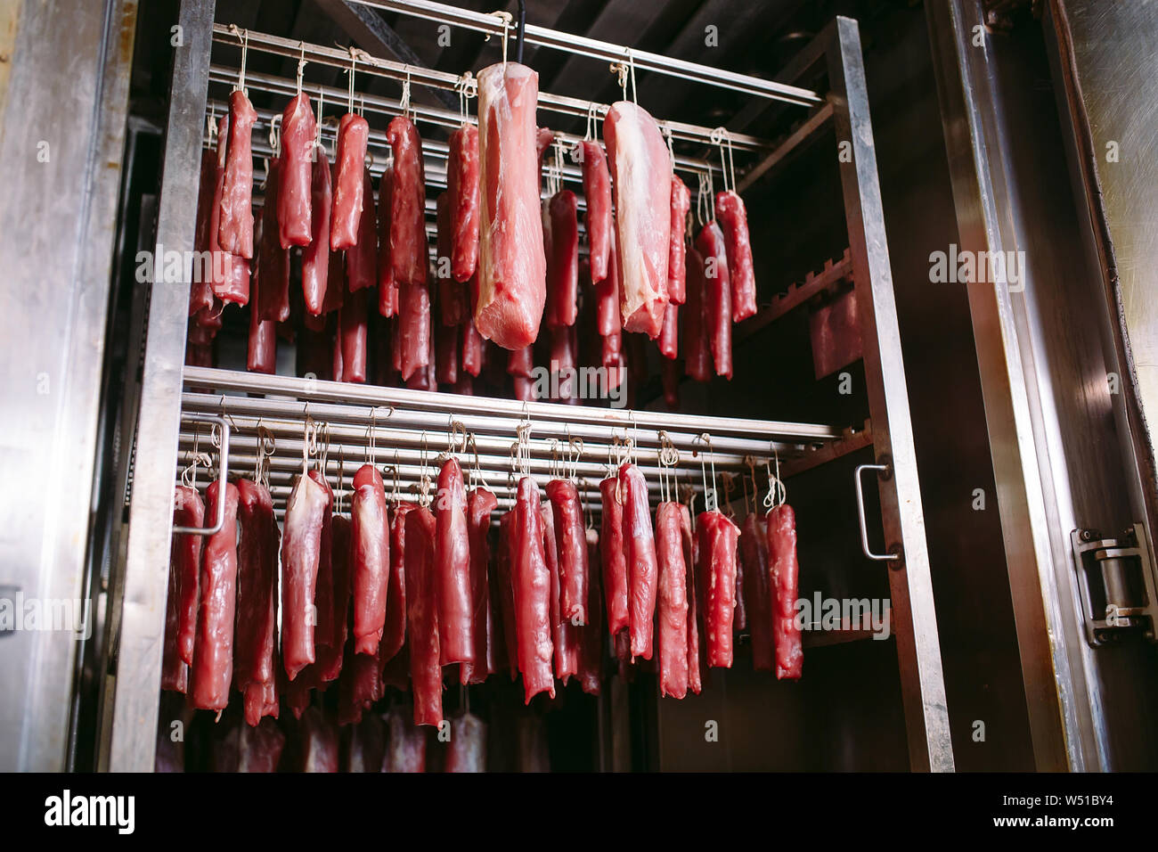 Smoked ham in the oven. Sausage production in the factory Stock Photo ...