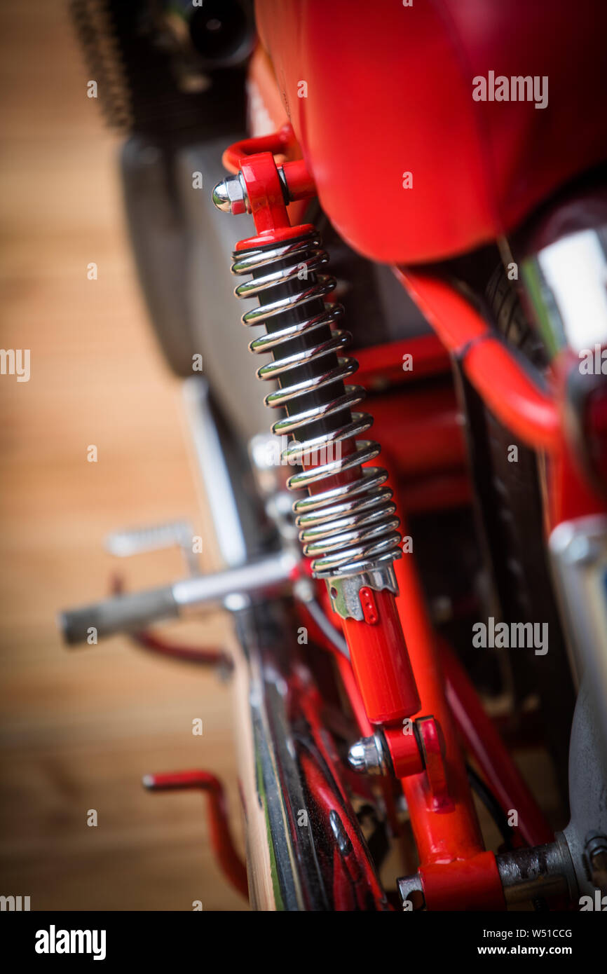 Color image of a red vintage motorcycle shock absorber Stock Photo - Alamy