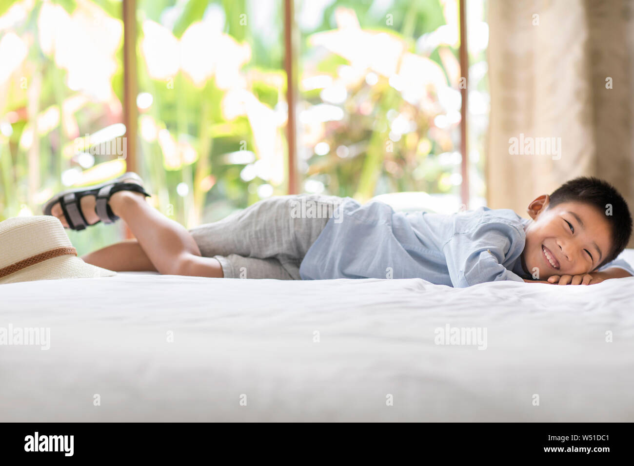 Little boy relaxing in hotel room Stock Photo - Alamy