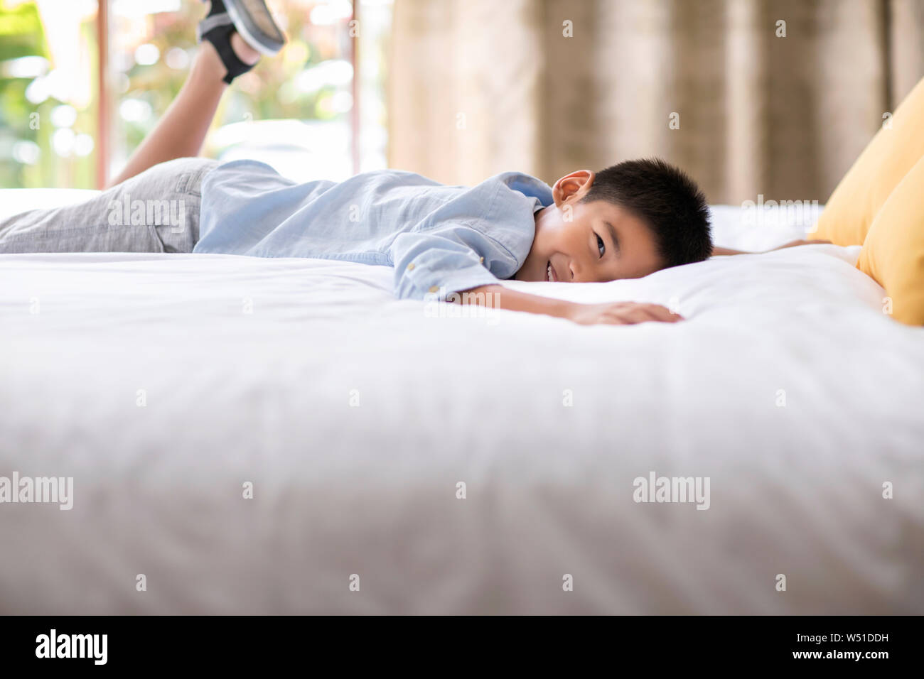 Little boy relaxing in hotel room Stock Photo - Alamy