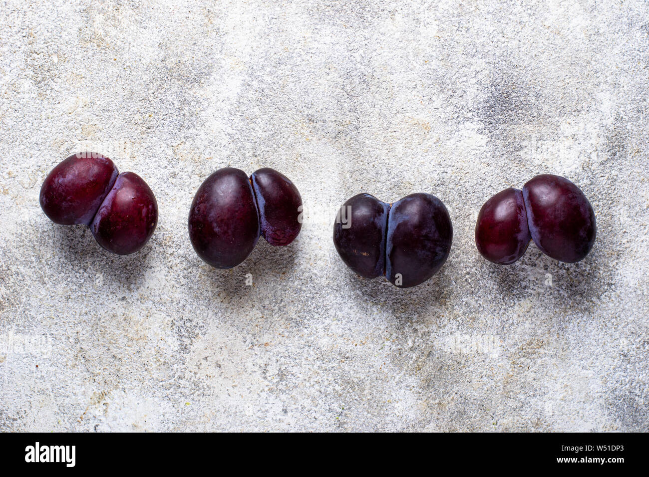 Ugly plums. Abnormal organic fruit Stock Photo - Alamy