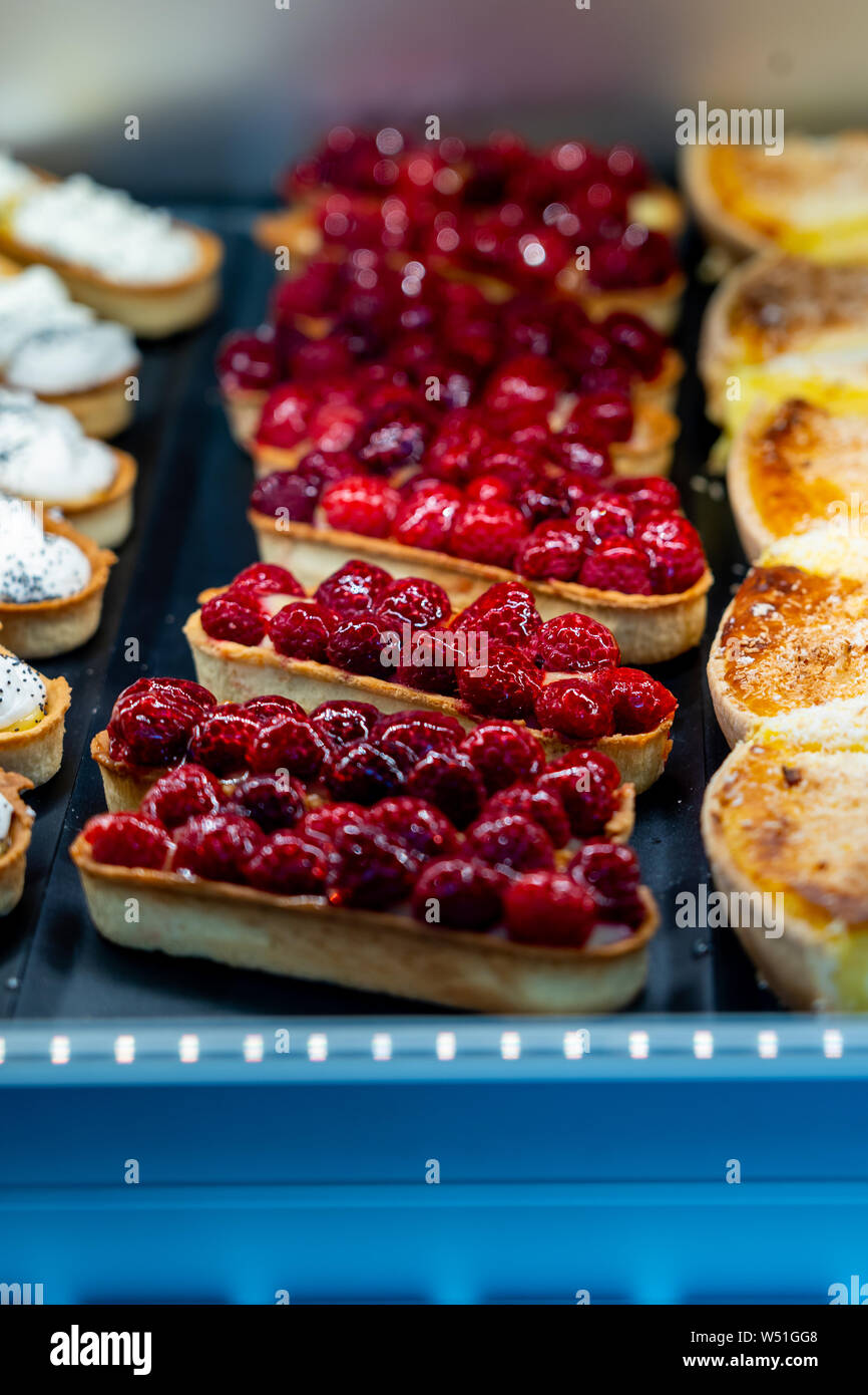 Delicious icing raspberry cream cheese tart in pastry shop Stock Photo ...